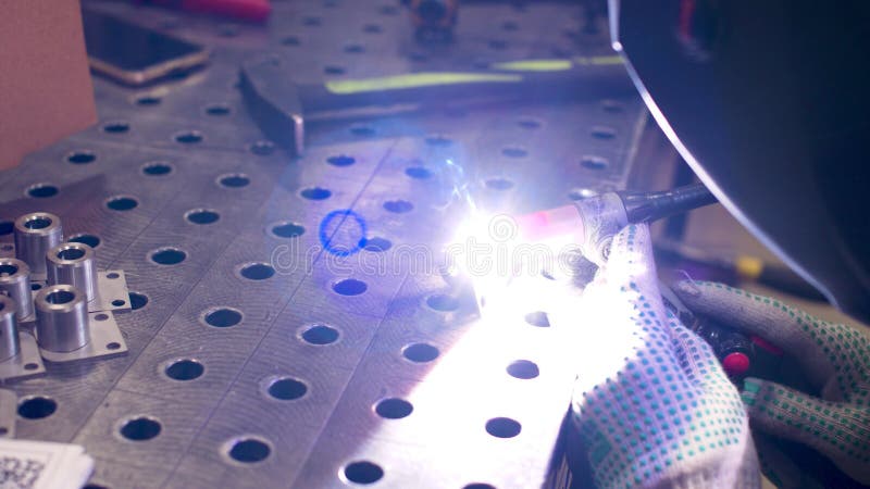 A Welder Makes a Precision Weld on a Stainless-steel Element. the ...