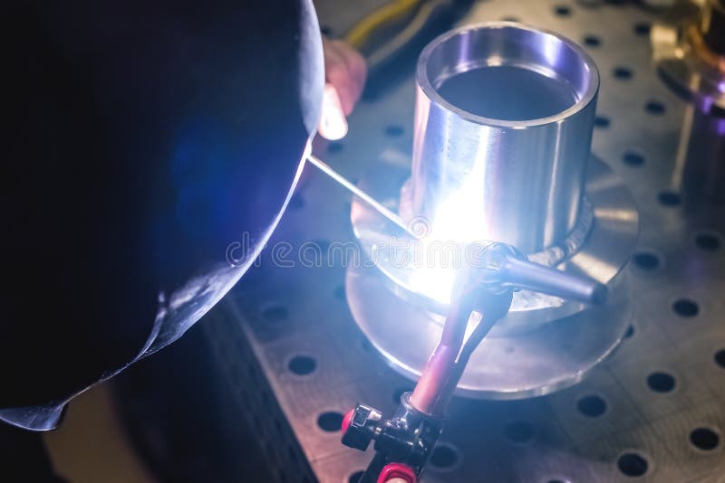 A Welder Makes a Precision Weld on a Stainless-steel Element. the ...