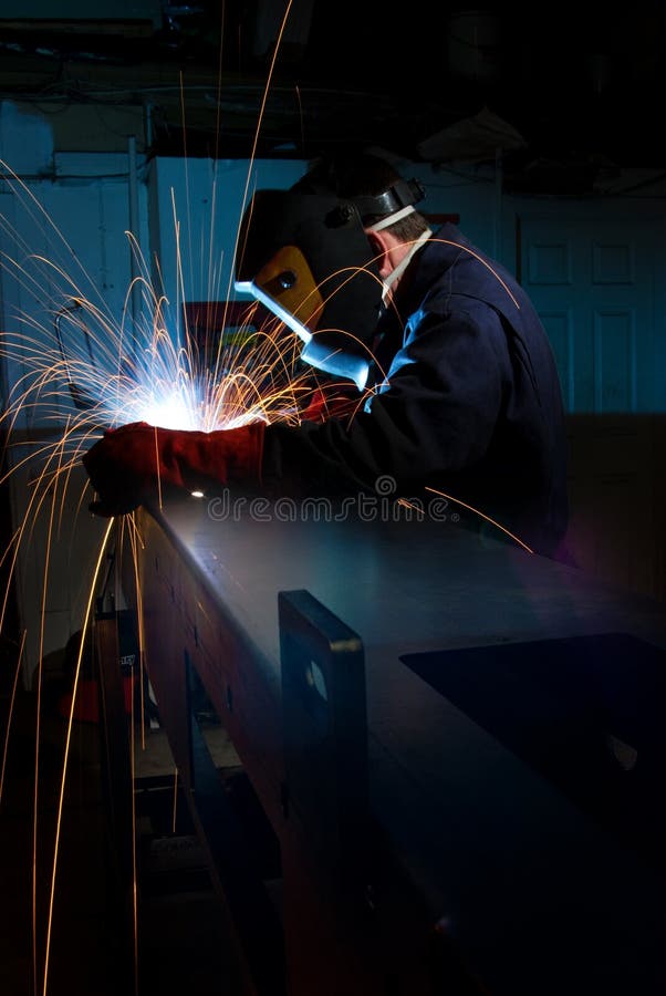 Blue lit MIG welder close stock image. Image of orange - 17363933