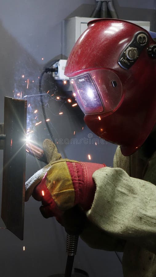 Welder in the Mask. the Metal Product is Welded by Welding Machine ...