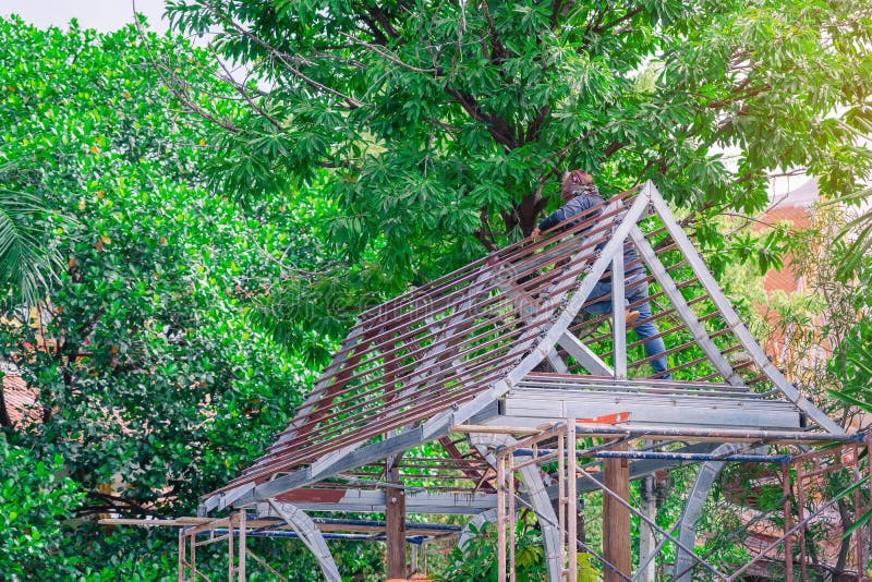 Welder and Painter are Helping To Build a Gable Roof Structure Stock ...