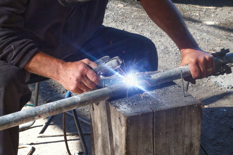 Welder& X27;s Hands, Welding an Iron Pipe Stock Photo - Image of soil ...