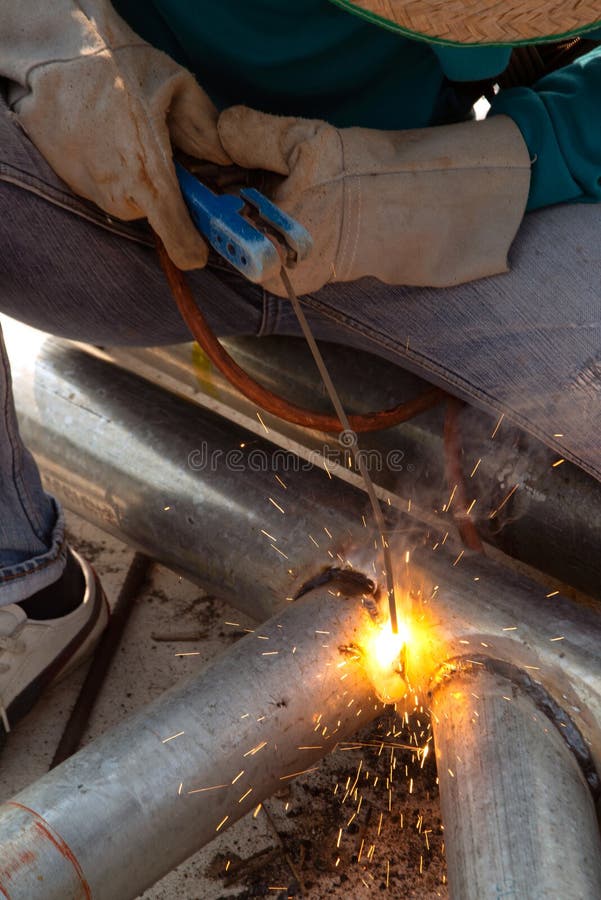The Welder is Sitting on the Steel Roof Frame and is Welding. Stock ...
