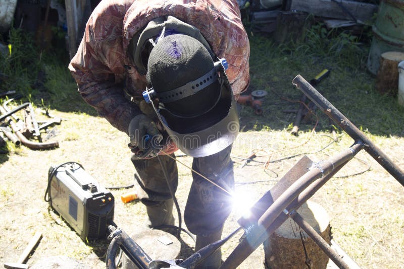A Welder in a Special Mask Performs Welding Work Stock Image - Image of ...