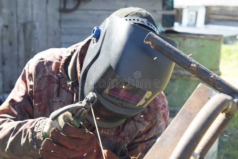 A Welder in a Special Mask Performs Welding Work Stock Image - Image of ...