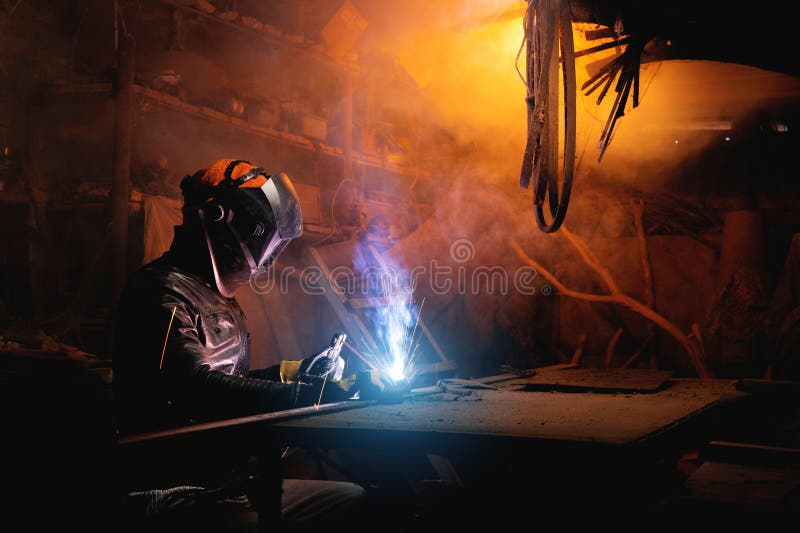 Welder Using Tool and Sparks are Generated, Welding Process in Garage ...
