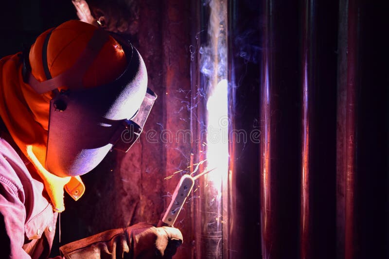 The Welder is Welding the Pipe Wall with Shielded Metal Arc Welding ...
