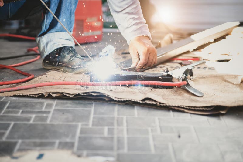 The Welder is Welding the Steel Structure To Add To the House. Stock ...