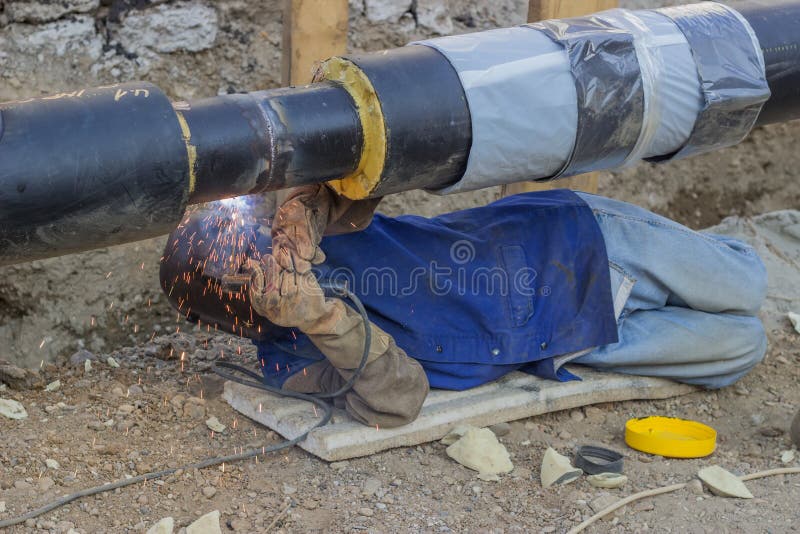 Welder Welding Underground Steel Pipe Lying on Ground Stock Photo ...