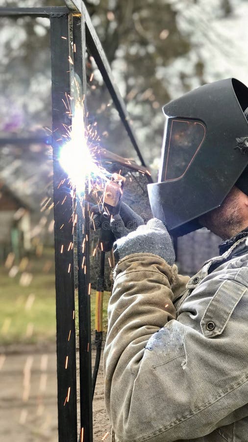A Welder Welds a Fence on the Street Stock Image - Image of works ...