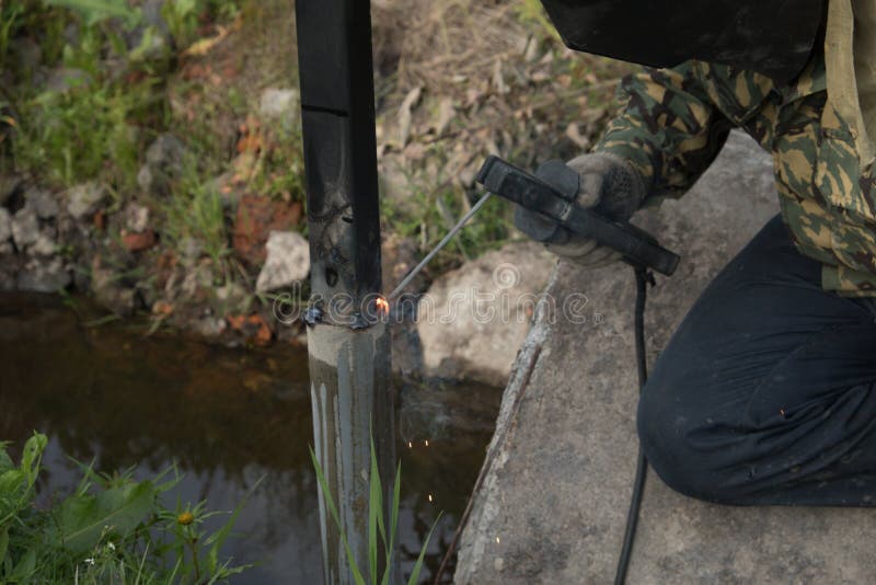 Installation of a Metal Column Using a Welding Machine Stock Photo ...