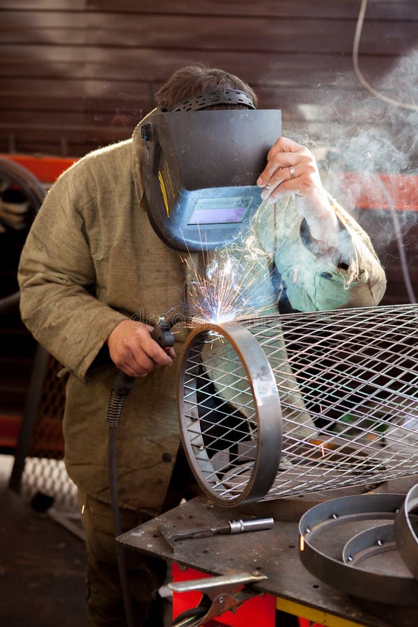Welder at work, with iron stock photo. Image of factory - 184835076