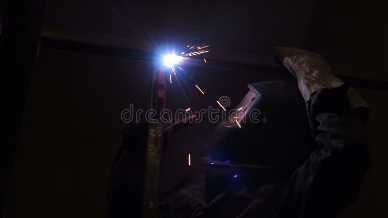 Welder Worker Performs Jump Welding. Worker Welder Performs Arc-Welding ...