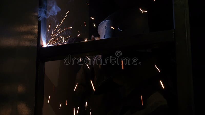 Welder Worker Performs Jump Welding. Worker Welder Performs Arc-Welding ...