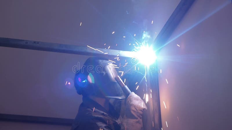 Welder Worker Performs Jump Welding. Worker Welder Performs Arc-welding ...