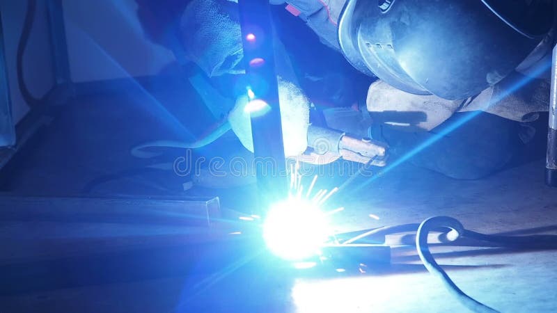 Welder Worker Performs Jump Welding. Worker Welder Performs Arc-welding ...
