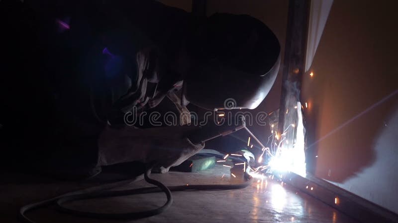Welder Worker Performs Jump Welding. Worker Welder Performs Arc-welding ...