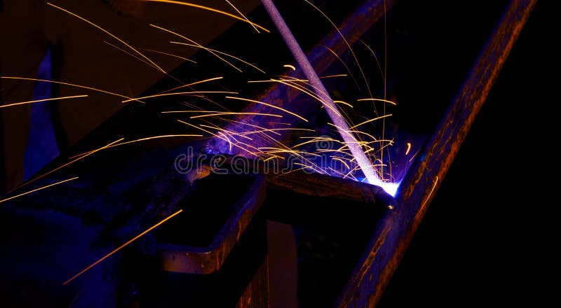 Welder Worker Performs Jump Welding. Man Welder in Protective Gloves ...