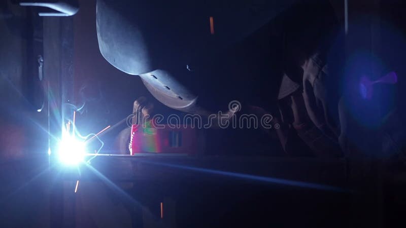 Welder Worker Performs Jump Welding. Worker Welder Performs Arc-welding ...