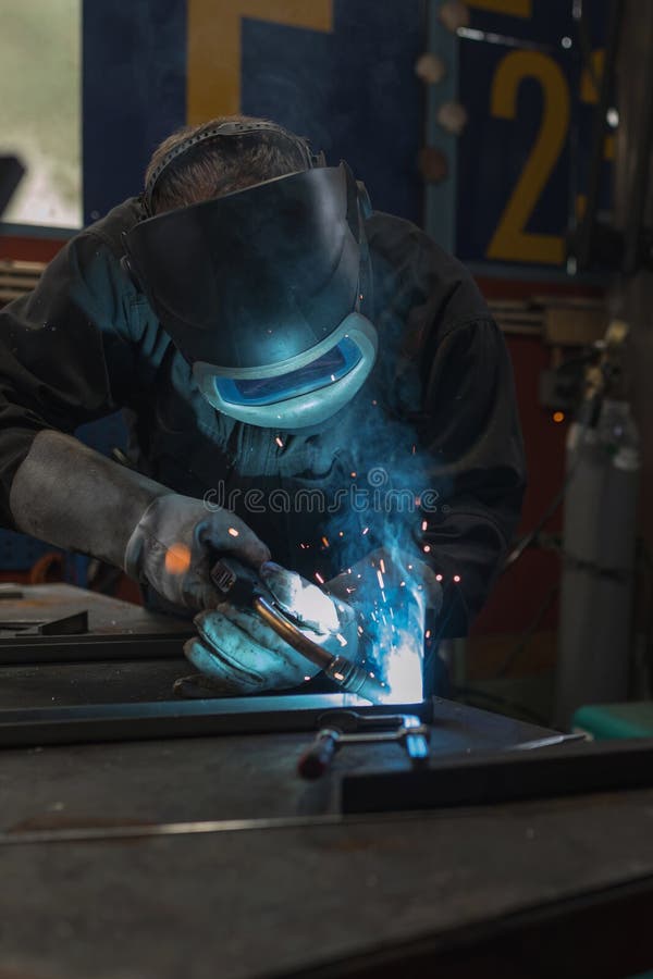 Welder Worker Using Welding Techniques To Create Sparks and Shape Metal ...