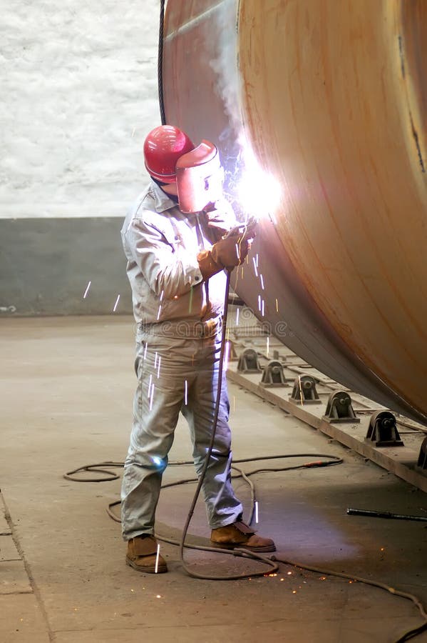 Welder in Man Lift Welding on Ship Hull Stock Photo - Image of welder ...