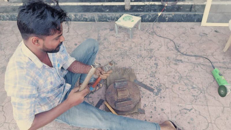 Welder Working on a Project Outdoors with Tools and Iron Angle Shaping ...