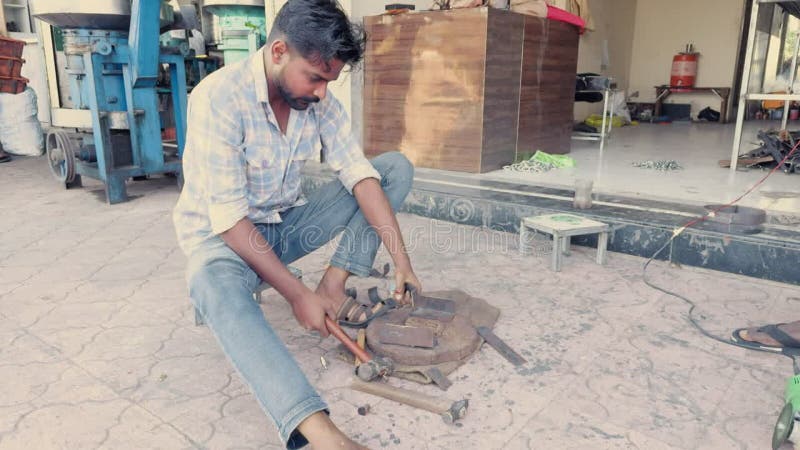 Welder Working on a Project Outdoors with Tools and Iron Angle Shaping ...