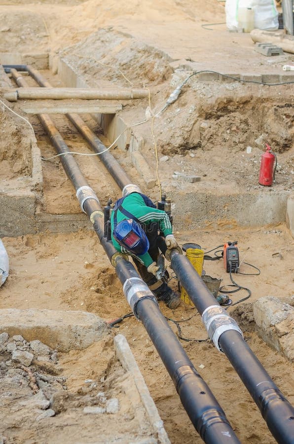 Welder Working on Underground Pipeline Installation at a Construction ...