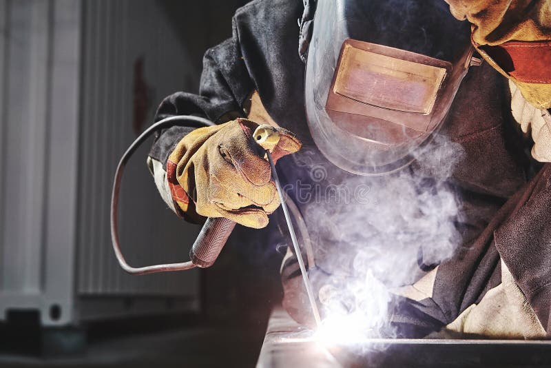 Welder Working with Welding on Metal Frames in an Industrial Plant ...