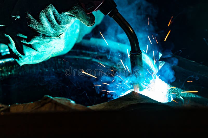 A Welder in a Workshop Manufactures and Connects Metal Structures, a ...
