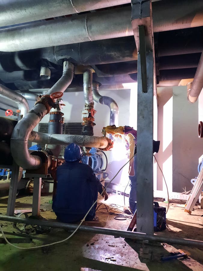 Welders welding pipes stock image. Image of welding - 265479521