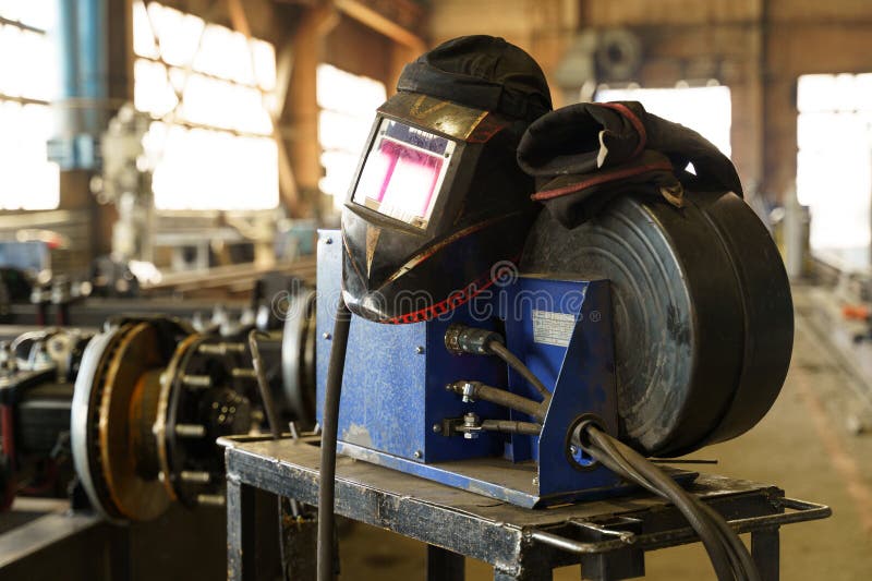 Welding Equipment on a Workshop Table in a Busy Industrial Setting ...