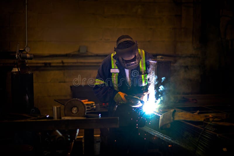 Welding in a factory stock photo. Image of mask, assembly - 129593470