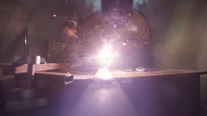Metalworker Using Welding Machine on Iron Surface, Smoke, Sparks and ...