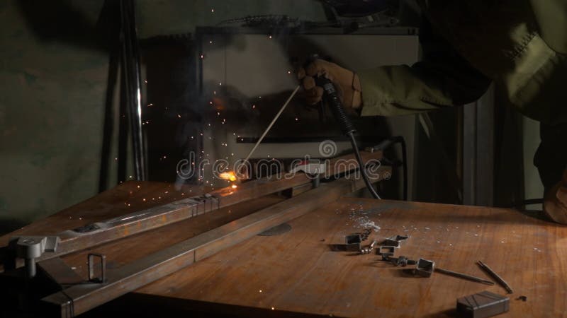 Metalworker Using Welding Machine on Iron Surface, Smoke, Sparks and ...