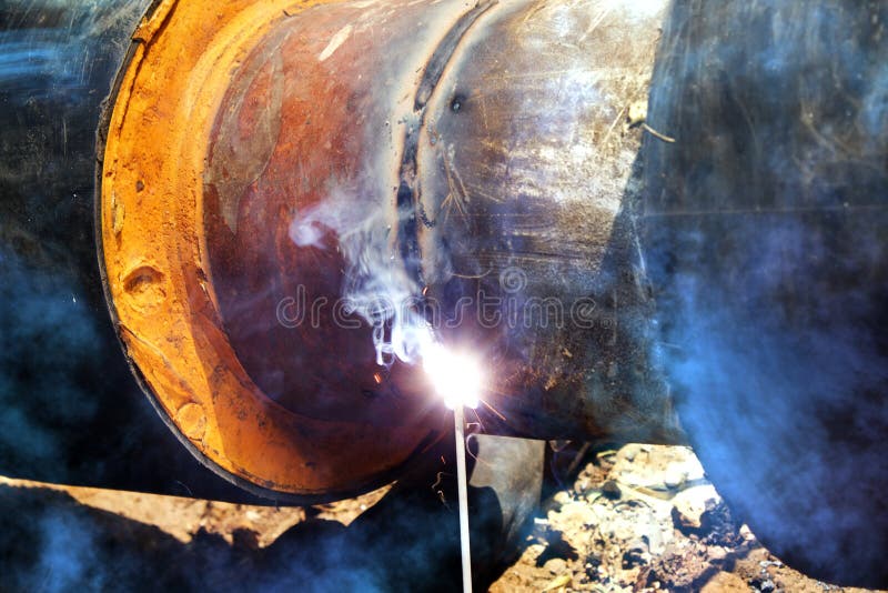 Welder working pipeline stock image. Image of seam, head - 15575461