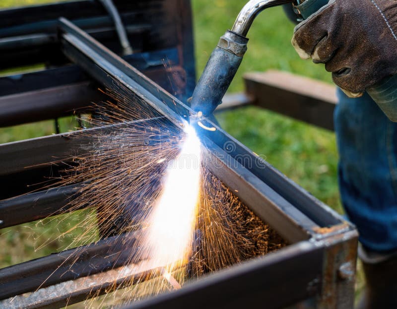 Welding Process in an Outdoor Workshop Demonstrating Skilled ...