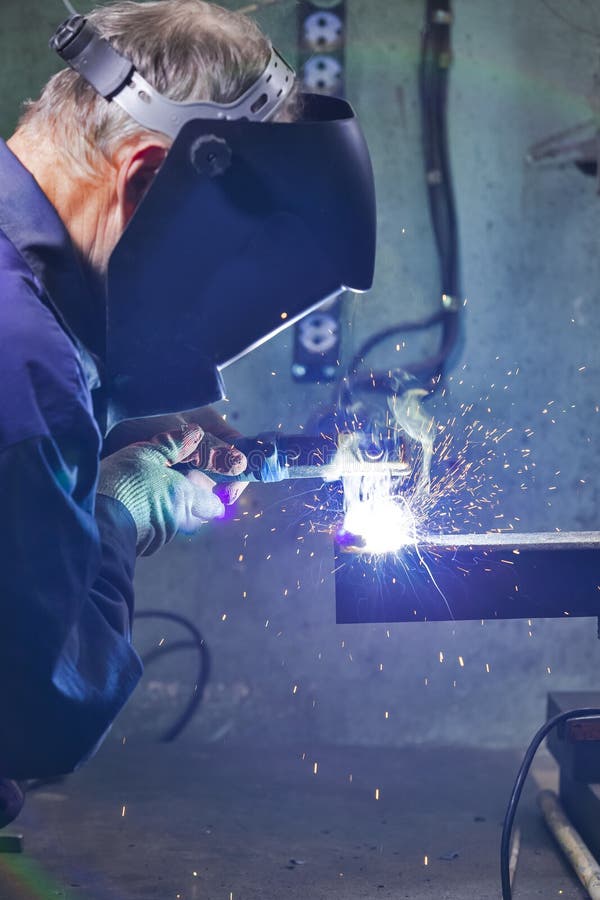 Welding Process with Sparks of Professional Welder in Protective Mask ...