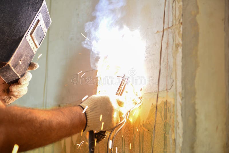 Welding Process on Steel Pipe Stock Photo - Image of yellow, mask ...