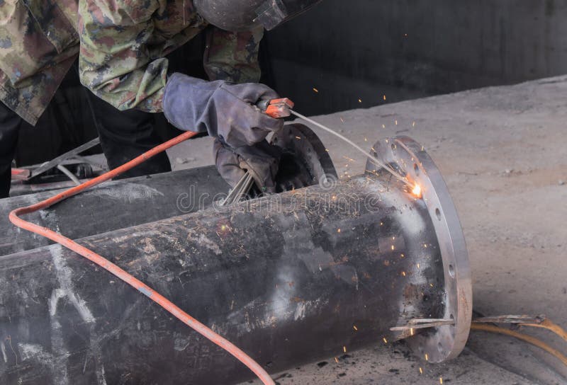Welding a steel pipe stock image. Image of factory, natural - 305783257