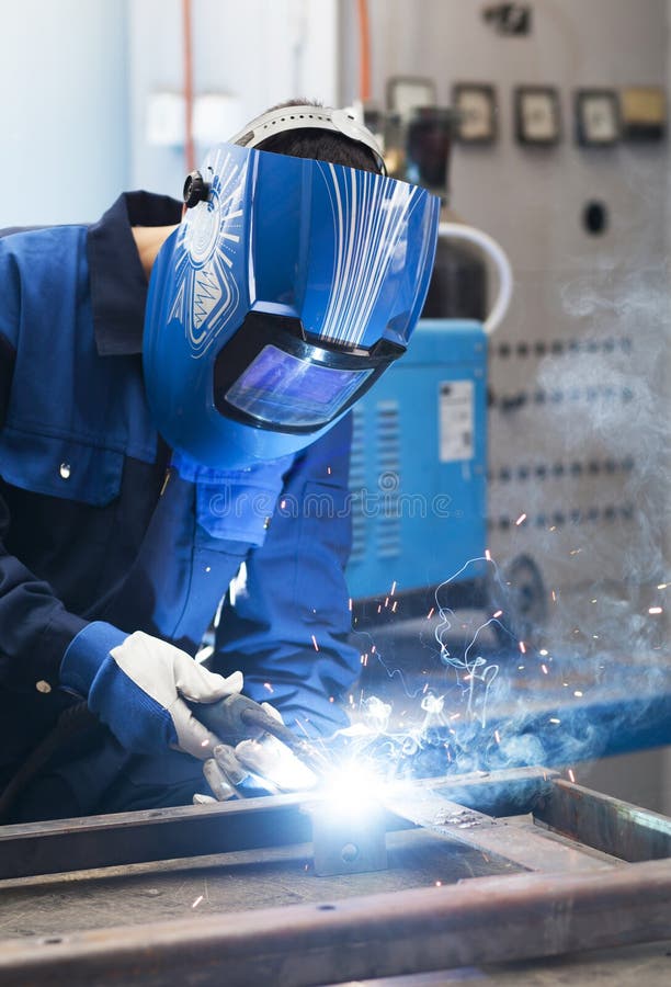 Man at Work: Industrial Welder with Spark Arcing Stock Image - Image of ...