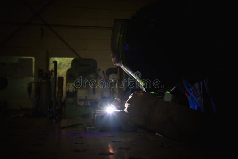 Welding Worker Welding with an Arc Welder, Welding with Welding Machine ...