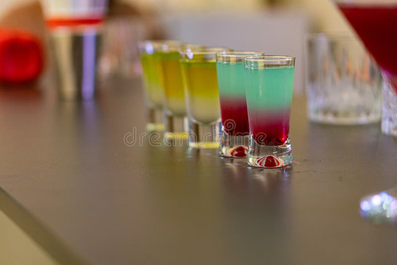 A Well-arranged Row of Martinis, Each with a Layered Gradient Color ...