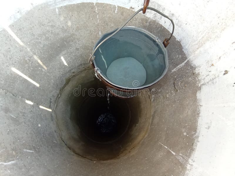 A Well with a Bucket Full of Water. the Sun S Rays Illuminate the Well ...