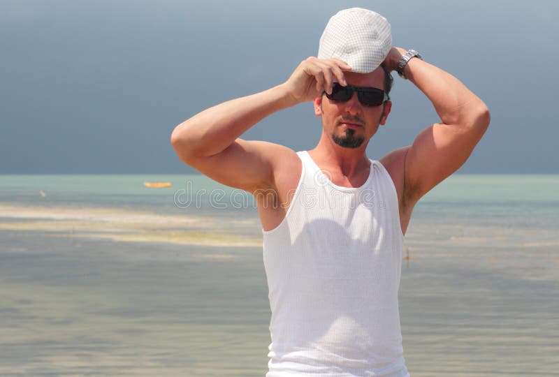 Man adjusting hat. stock photo. Image of ocean, glasses - 19421284