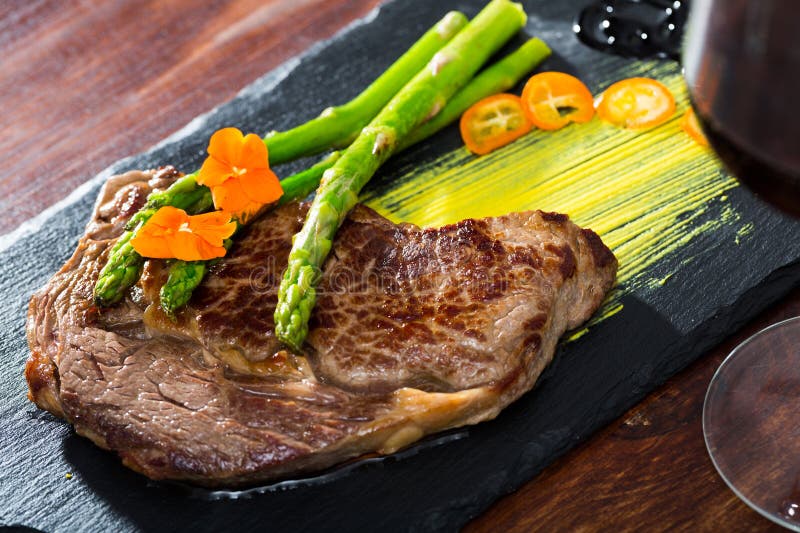 Well Done Beef Steak with Asparagus Stock Photo - Image of juicy, wood ...