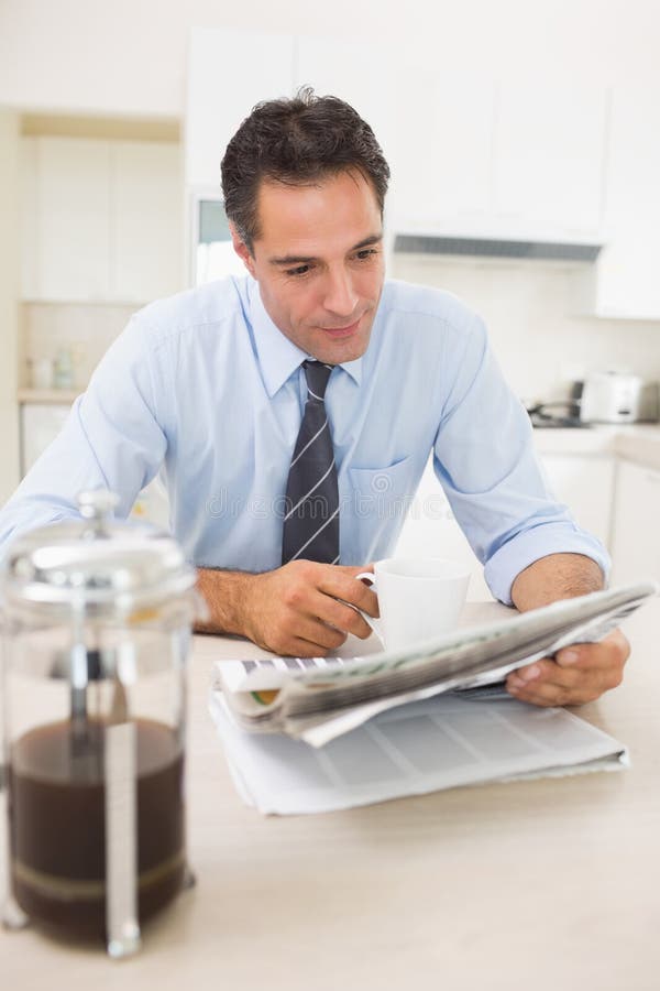 Well Dressed Man with Coffee Cup Reading Newspaper in Kitchen Stock ...