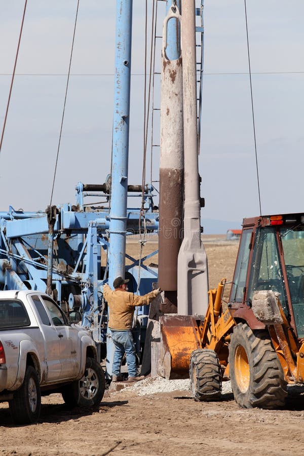 A Man Uses a Drilling Rig To Drill an Agricultural Well. Editorial ...