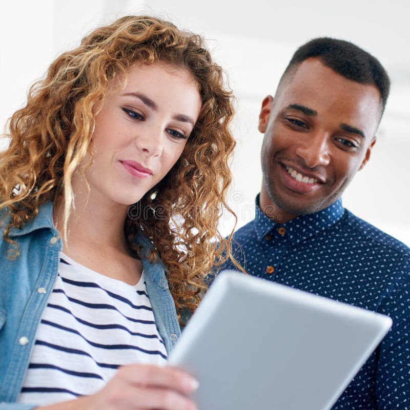 Well Get Any Job Done...together. Two Young Colleagues Using a Digital ...