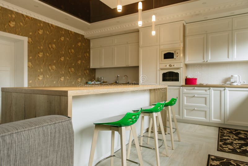 Well Illuminated Kitchen Room with the Big Long Counter in the Middle ...